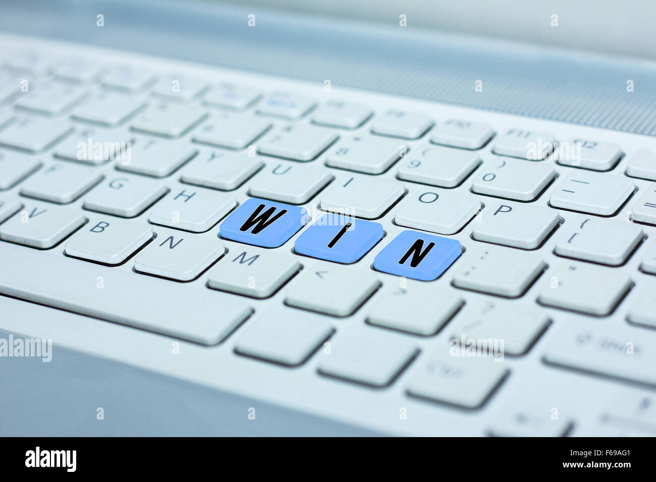 Keyboard with blue win button, business concept Stock Photo - Alamy