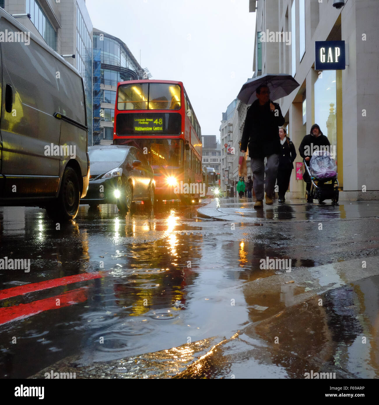 Road Traffic, puddles and commuters during rain in London Stock Photo ...