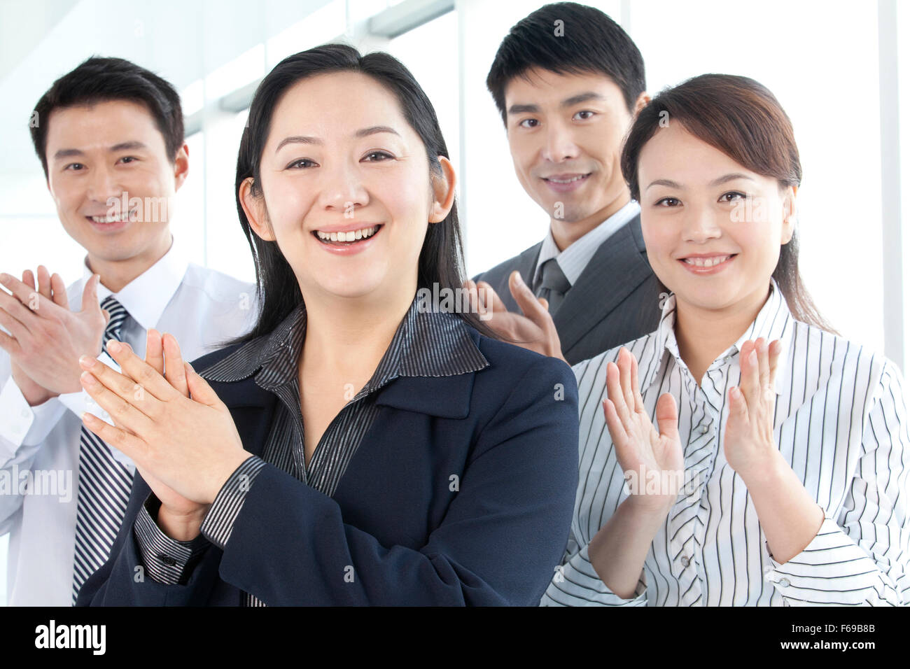 Chinese businesspeople clapping congratulating hi-res stock photography ...