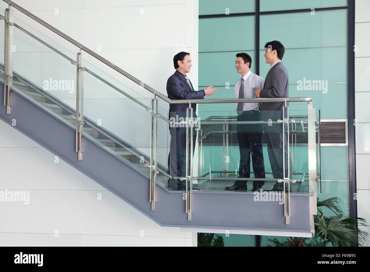 Three Businessmen on Stairway Stock Photo - Alamy