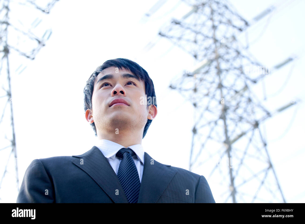 Businessman in Front of Power Lines Stock Photo - Alamy