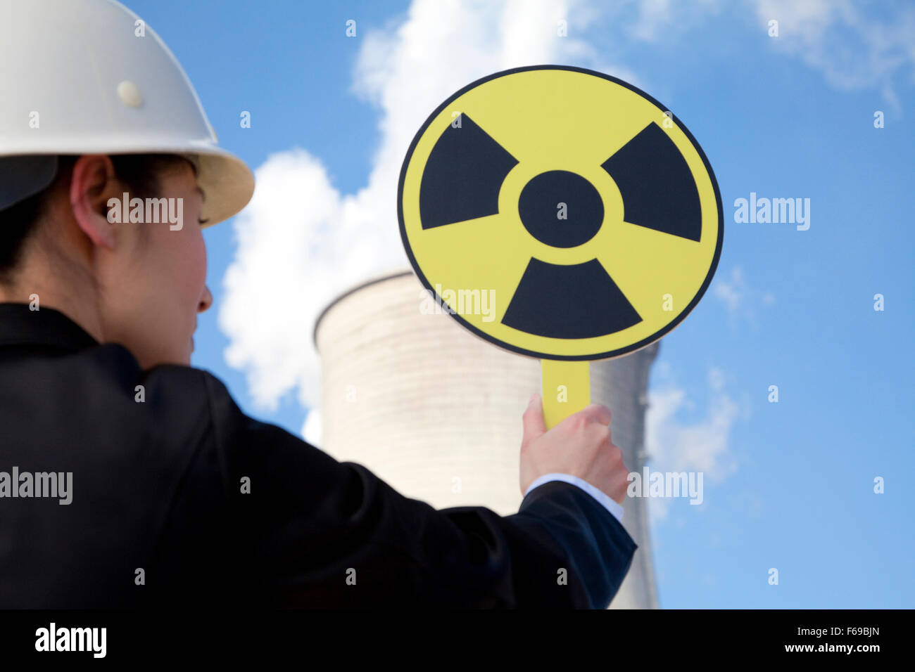 Engineer in front of cooling towers with sign Stock Photo - Alamy