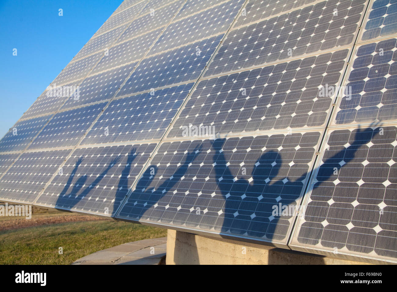 Shadows of Businesspeople with Arms Outstretched on Solar Panel Stock ...