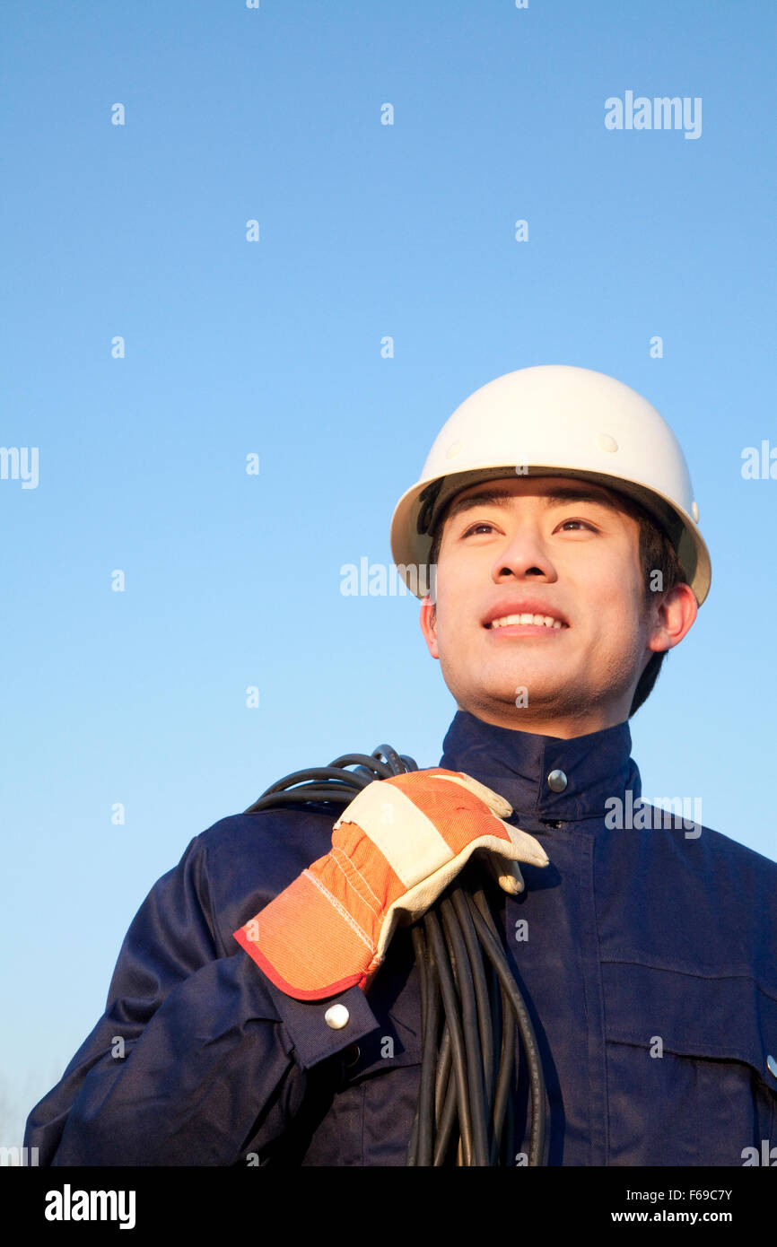 Manual worker looking away Stock Photo - Alamy