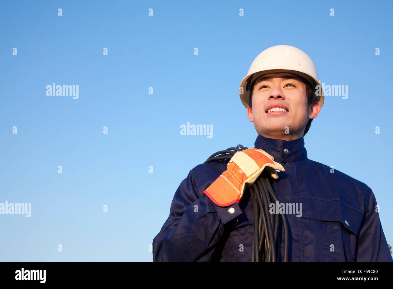 Manual worker looking away Stock Photo - Alamy