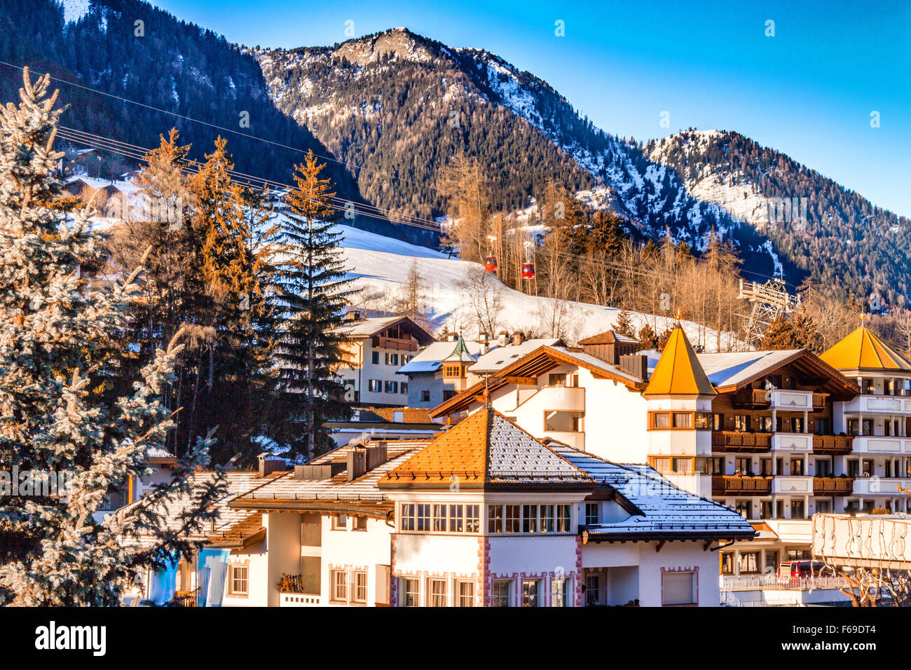 The roofs of a people friendly alpine town in the background of snowy ...