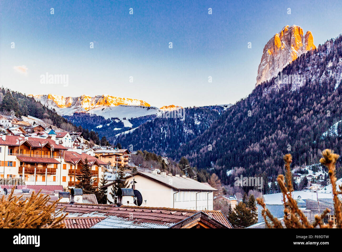 The roofs of a people friendly alpine town in the background of snowy ...