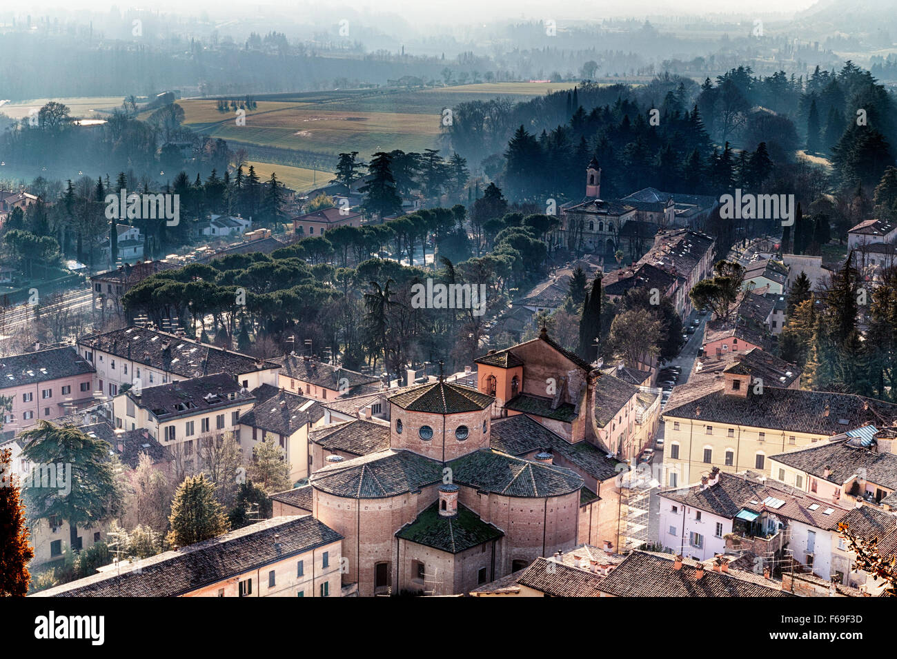 Tile roofs of Italian country village in a winter foggy and sunny day ...