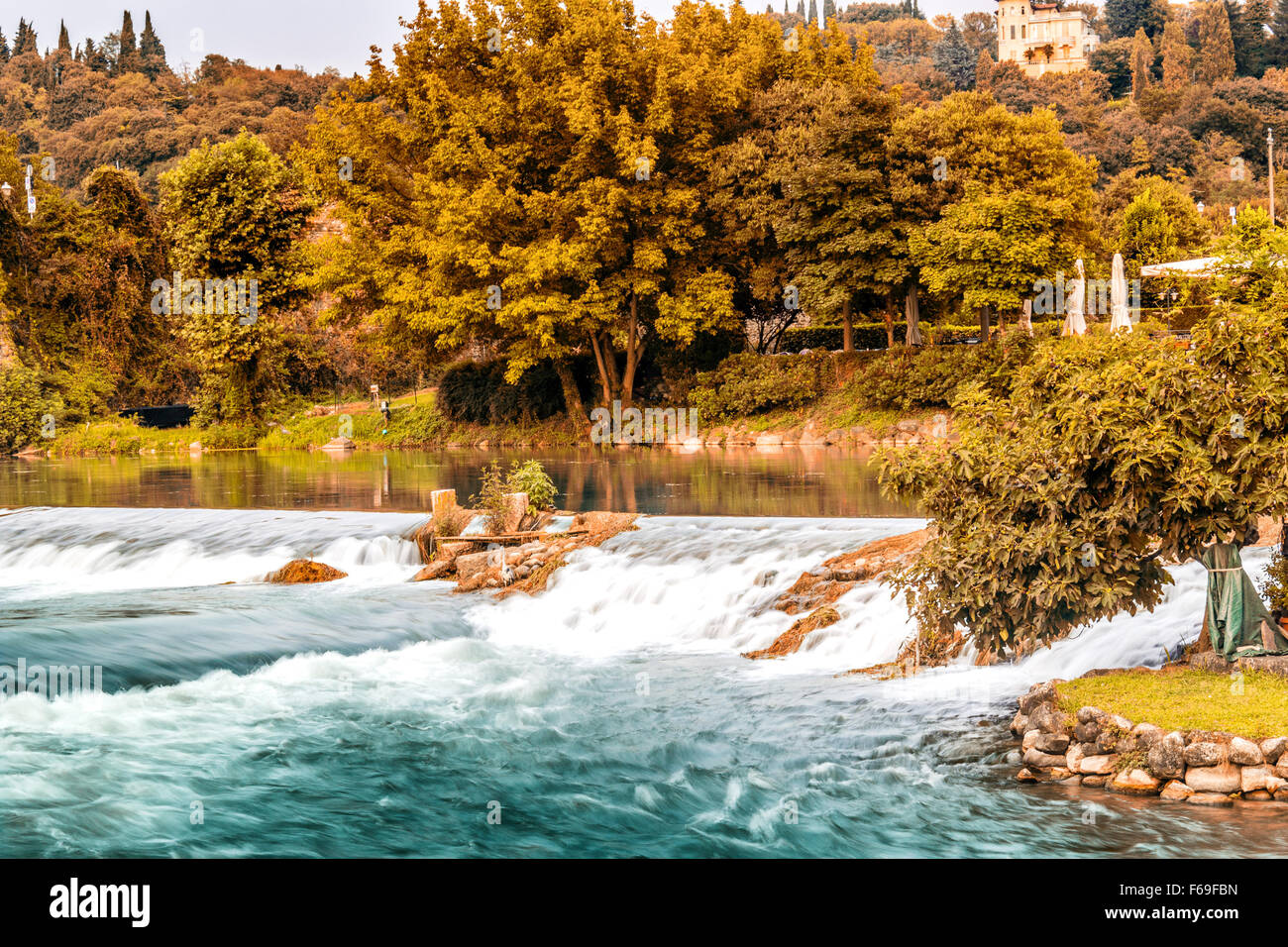 ancient buildings of a typical Italian medieval village: the river runs ...
