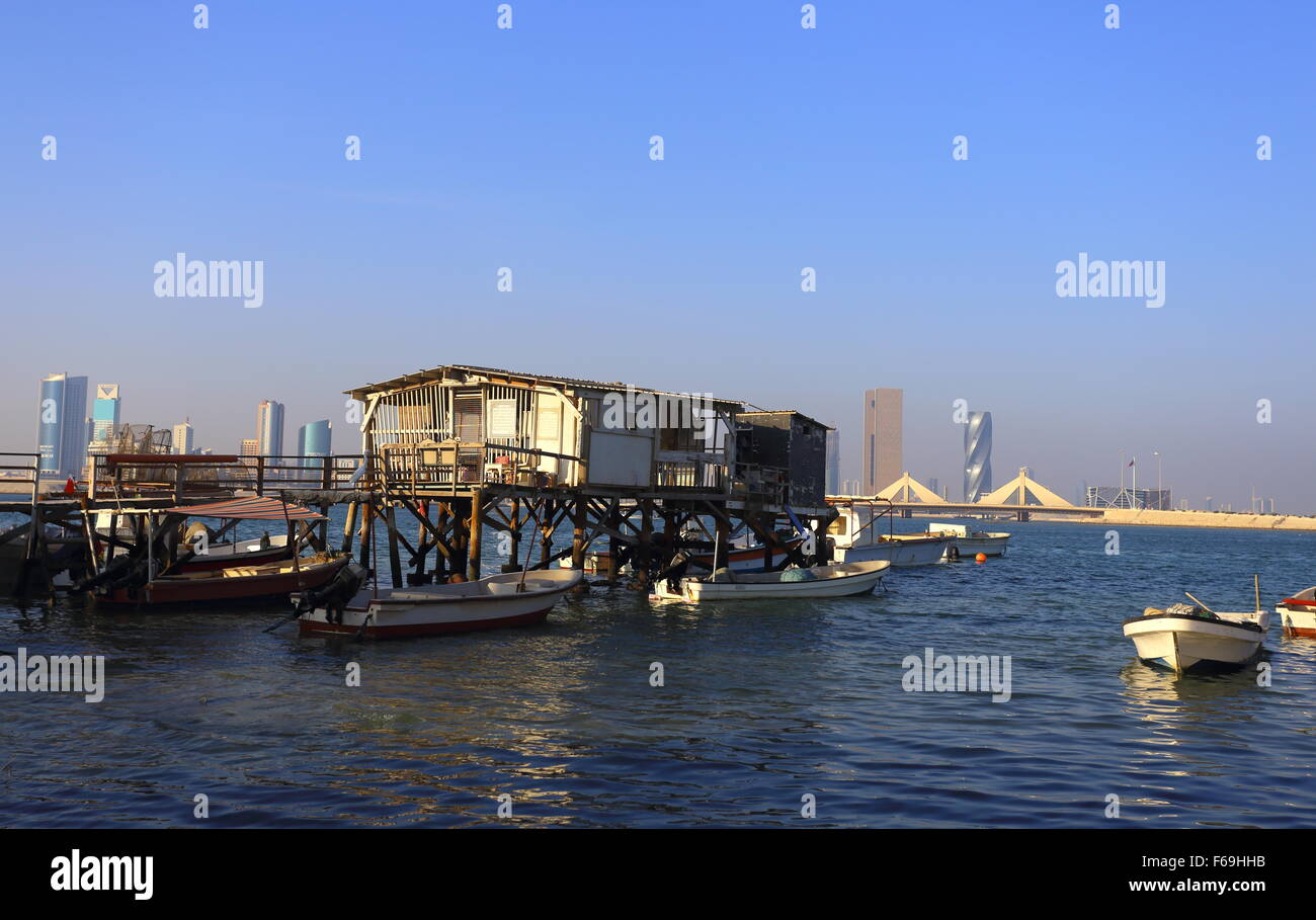 Fisherman's shed on a jetty with boats, Muharraq, Kingdom of Bahrain ...