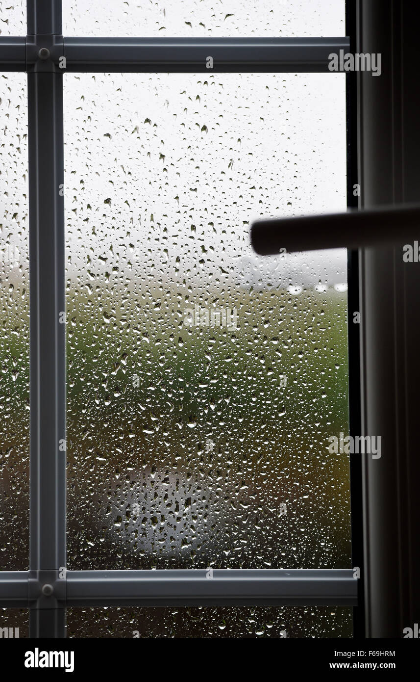 Raindrops on glass window pane on bad weather day UK Stock Photo - Alamy