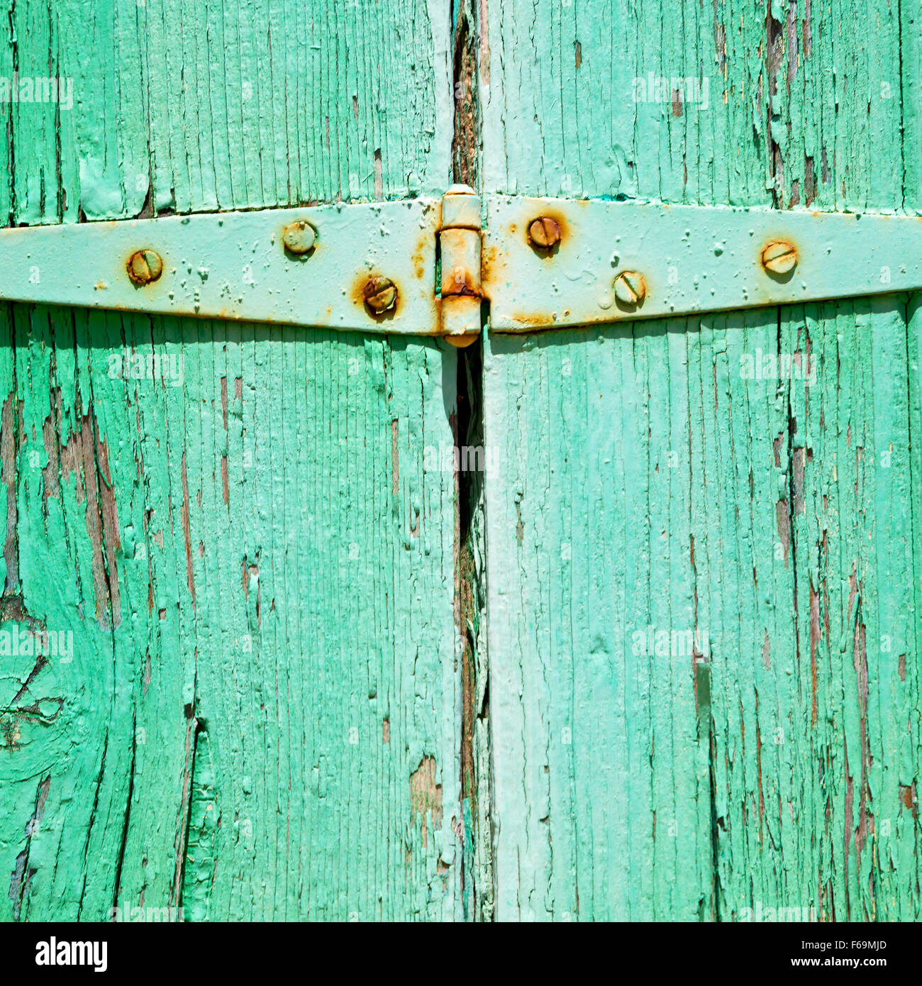 in the old wall a hinged window green wood and rusty metal Stock Photo ...