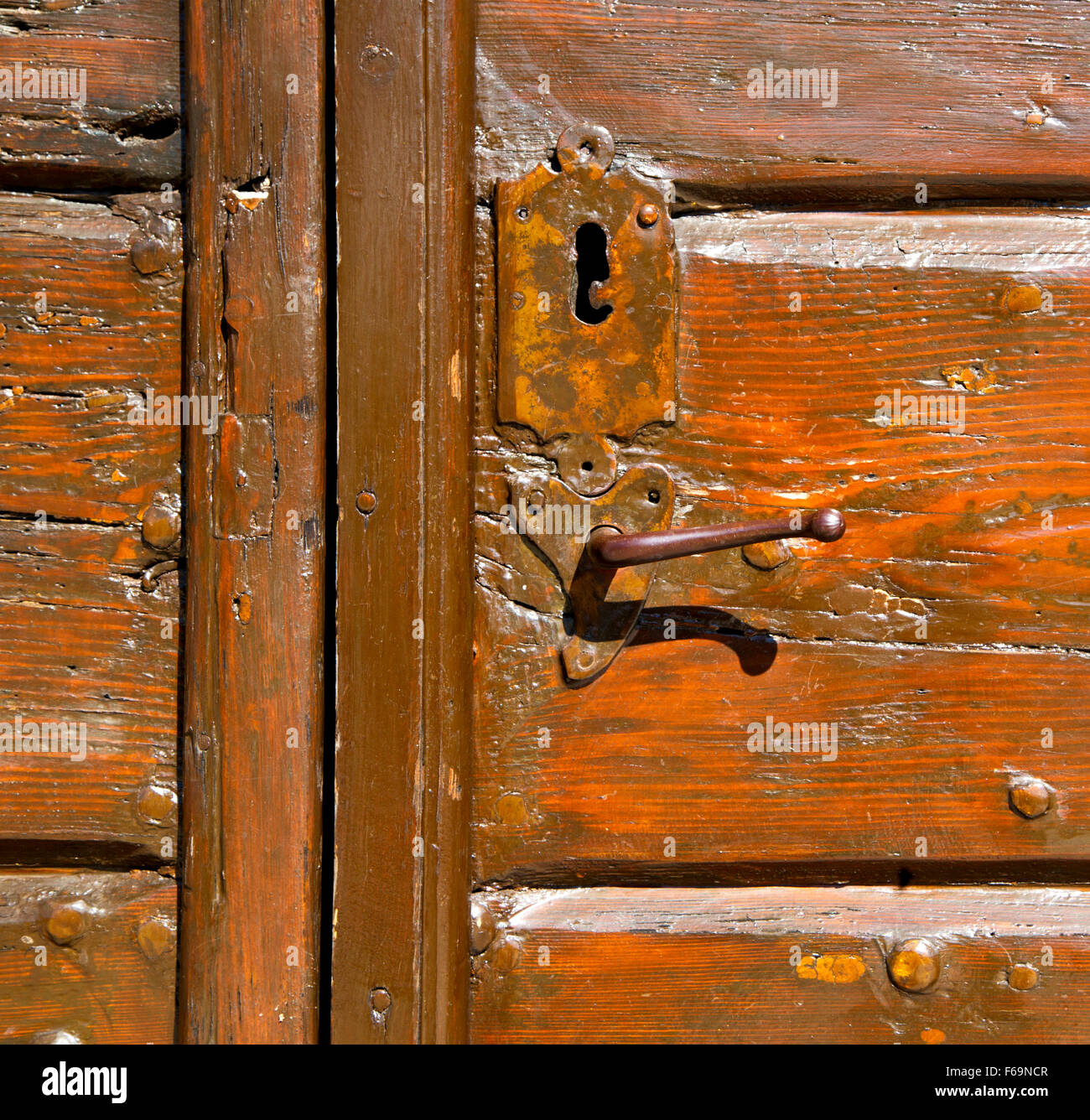 samarate abstract rusty brass brown knocker in a door curch closed wood ...
