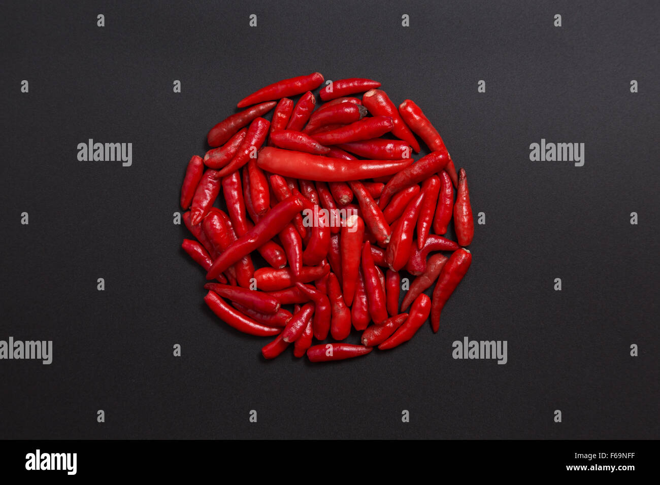 Non-stem red bird eye chili peppers on grey background Stock Photo - Alamy