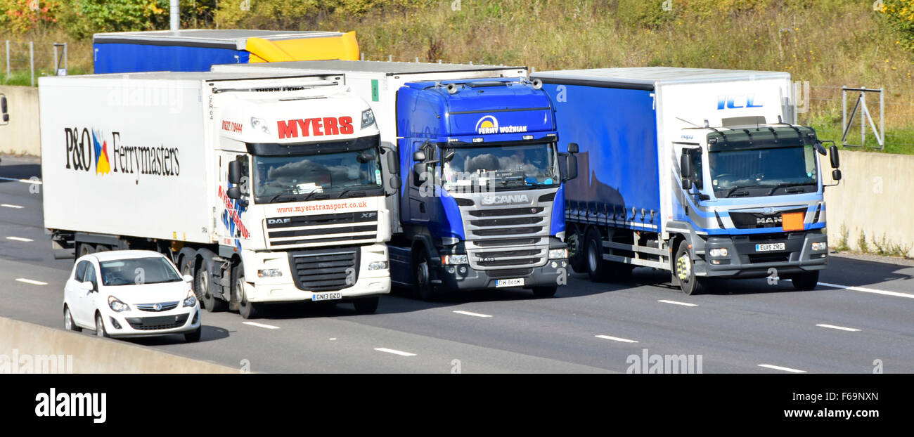 Little and large car & lorry trucks overtaking on four lane English UK ...