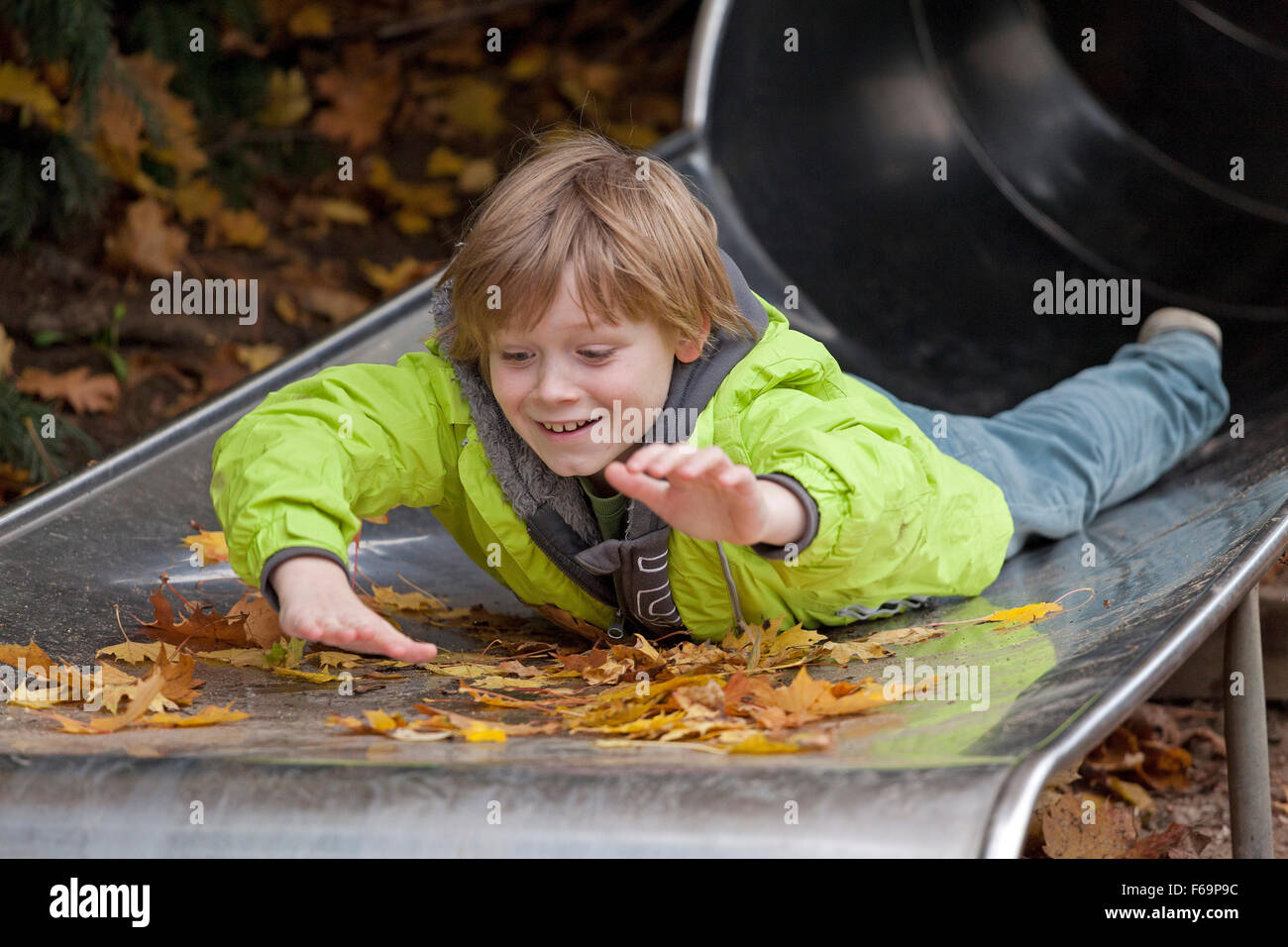 young boy on a slide Stock Photo - Alamy