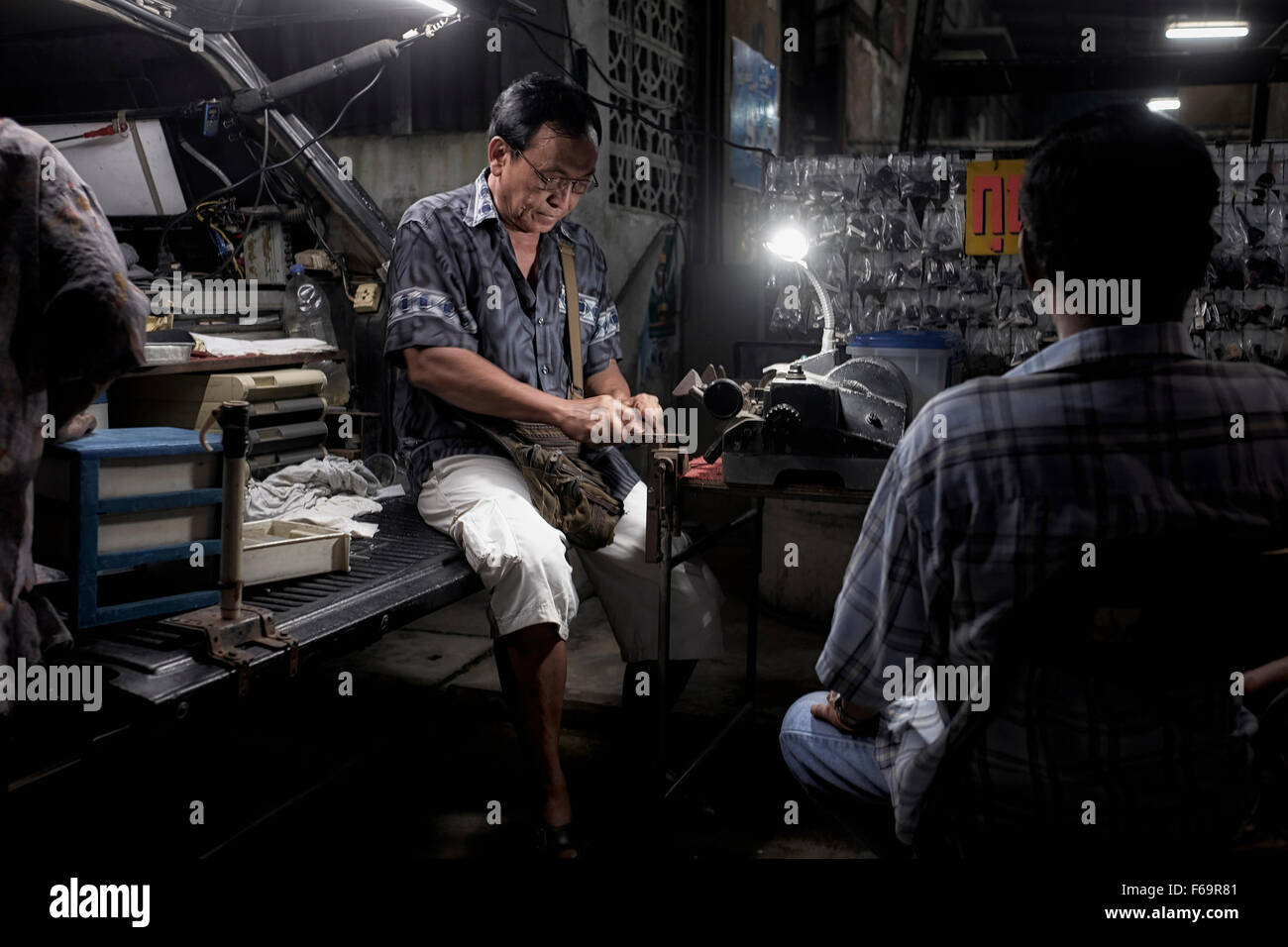 Night work. Key cutter working at night. Thailand street scene Stock ...