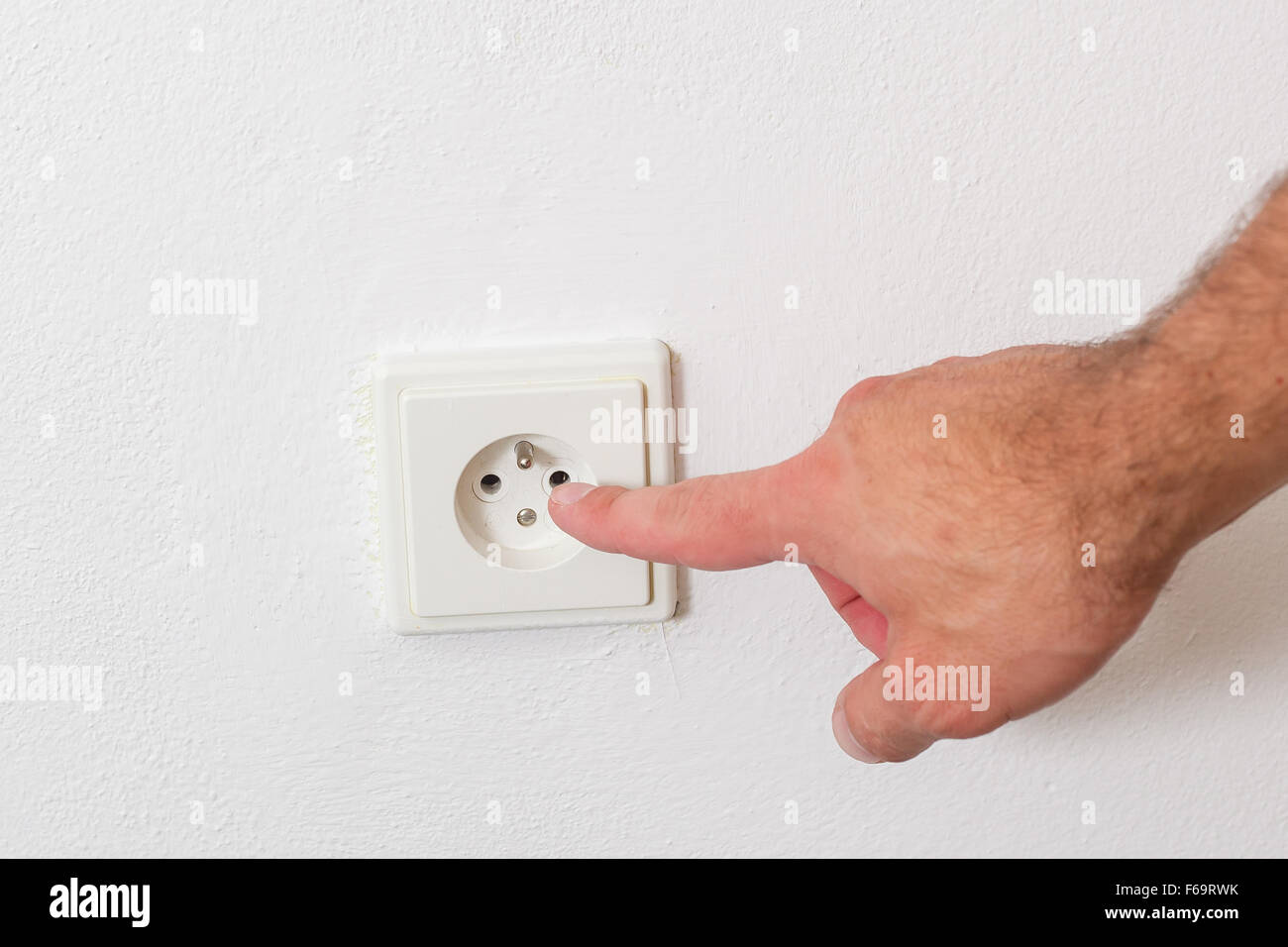 fingers in the electric socket (White background Stock Photo - Alamy