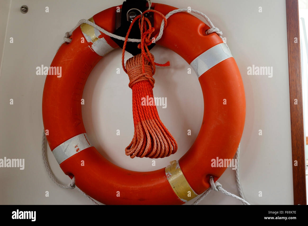 Orange life belt on a small ship In Italy Stock Photo - Alamy