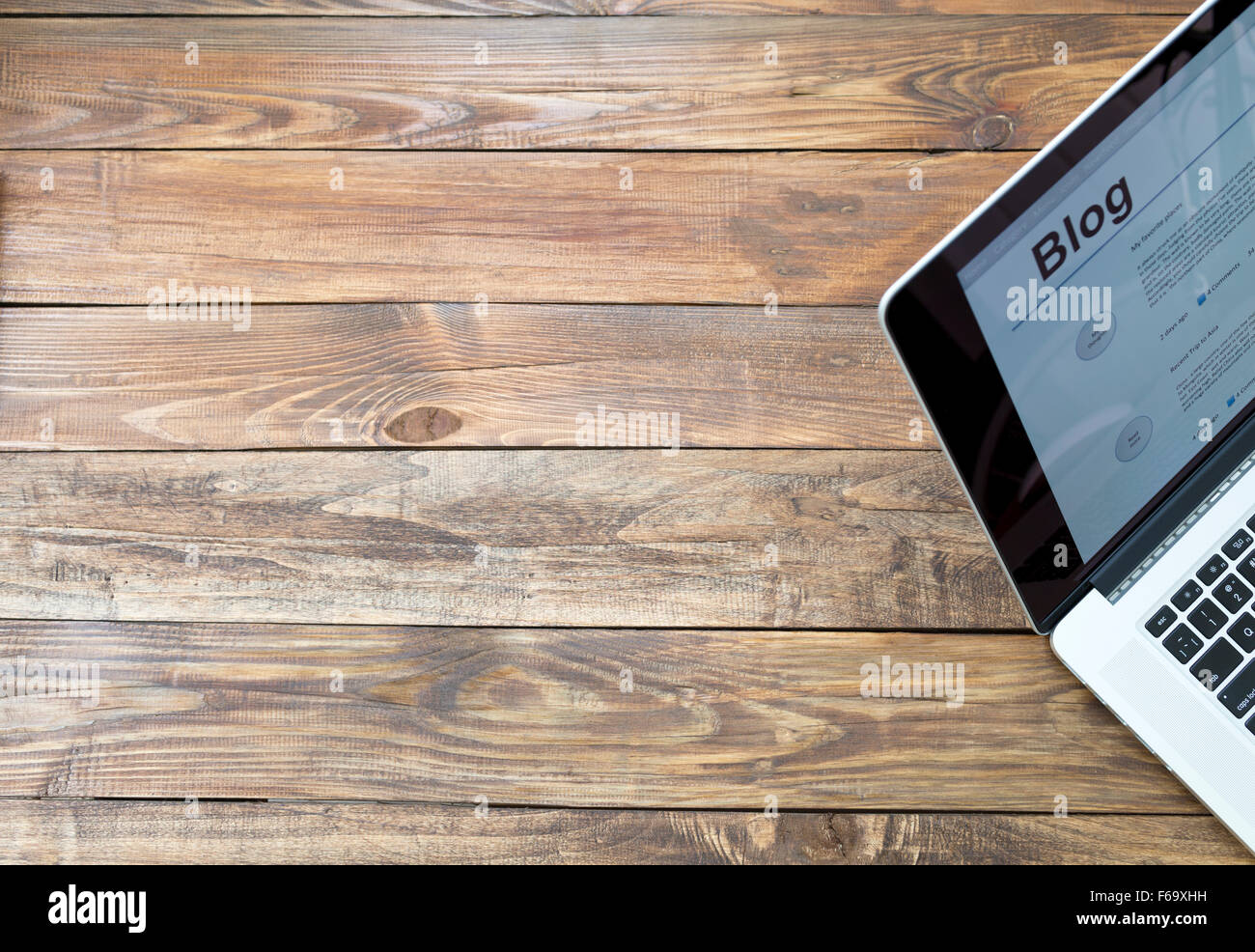 Desk of blogger Rough wooden desk and cropped laptop Stock Photo - Alamy