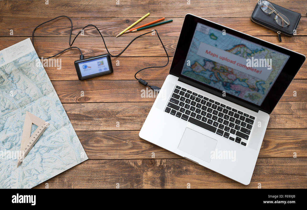 Preparing for trip Wooden desk at home laptop with map Stock Photo - Alamy
