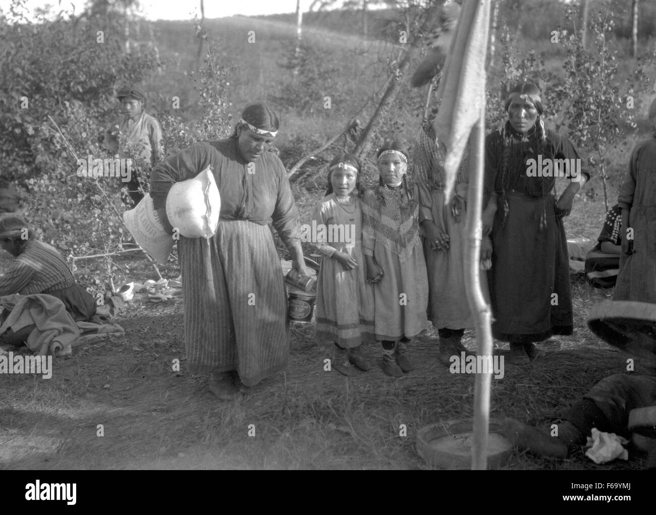 A Cree woman is pictured carrying domestic supplies along the Waterhen ...