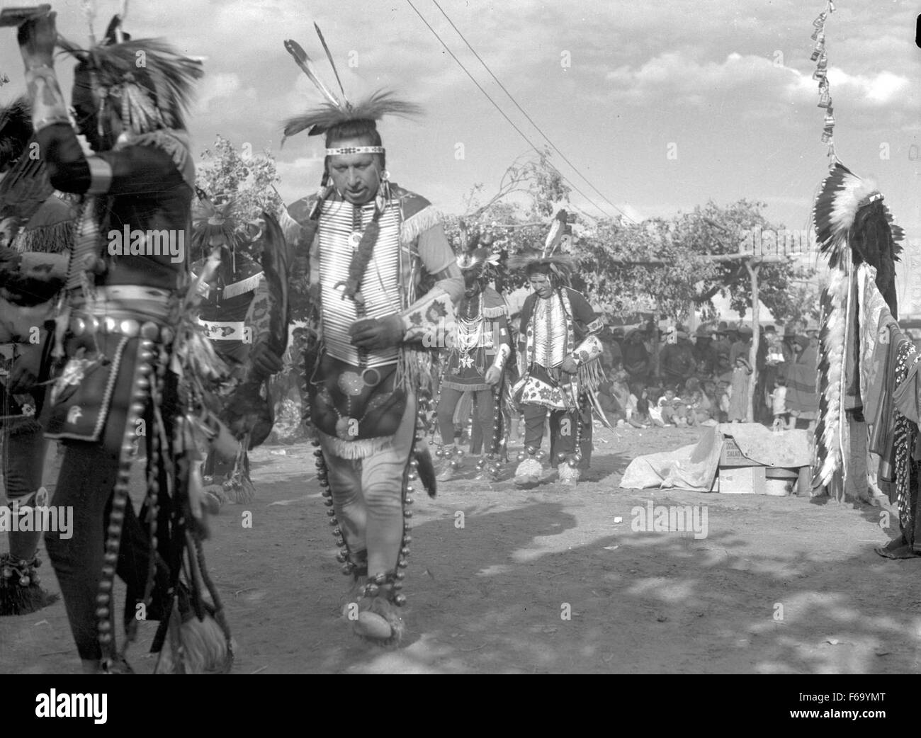 This photograph shows a group of Indigenous dancers heading to a Pow ...