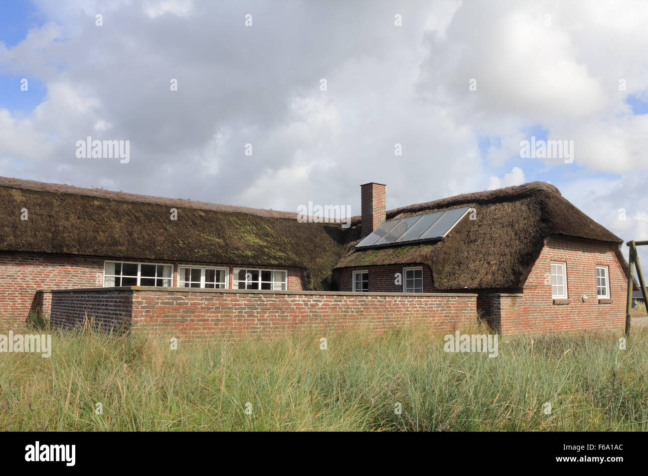 Thatched house with solar heating in the sand dunes at Houvig Strand ...