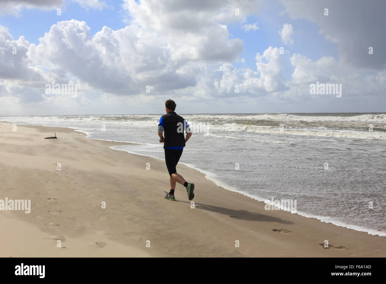 Jogger on the beach at Houvig Strand, Søndervig, Jutland, Denmark Stock ...