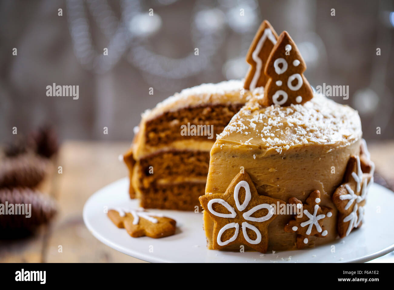 Ginger cake with gingerbread decorations Stock Photo - Alamy