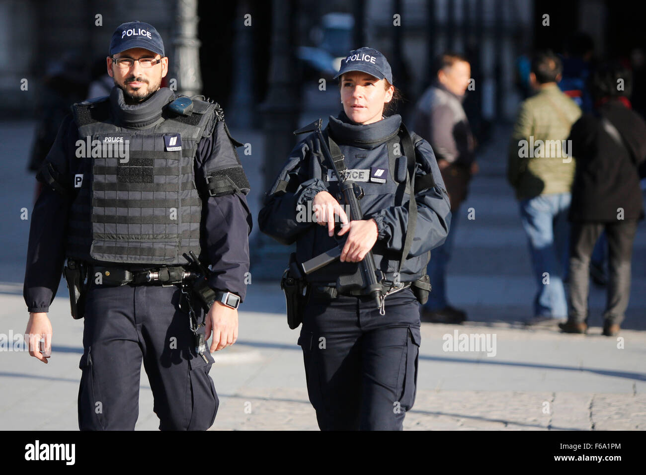 Paris, France. 15th Nov, 2015. Police walk around the closed-Louvre ...