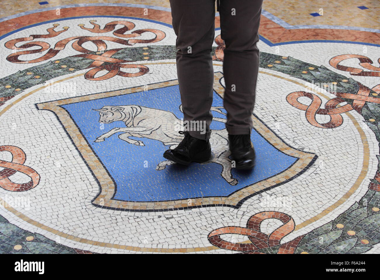 SPINNING ON THE BULL FOR GOOD LUCK - MILAN, ITALY Galleria Vittorio ...