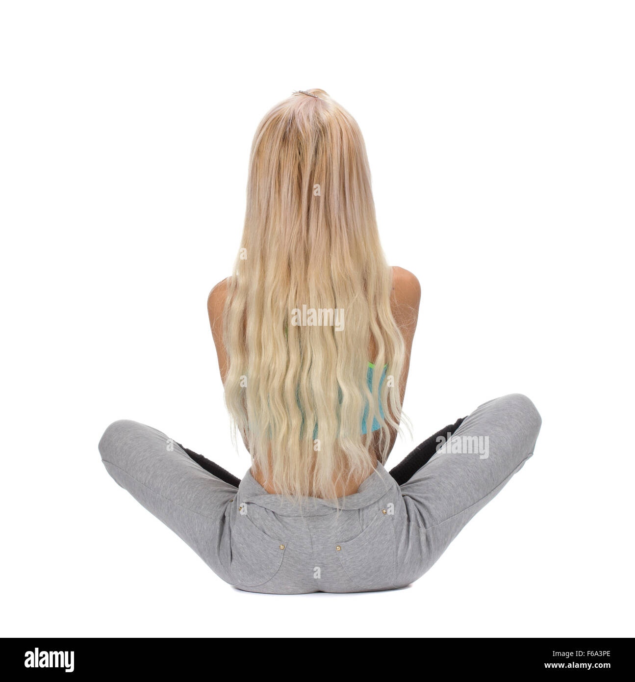 Portrait of young woman meditating in pose of lotus, back view ...