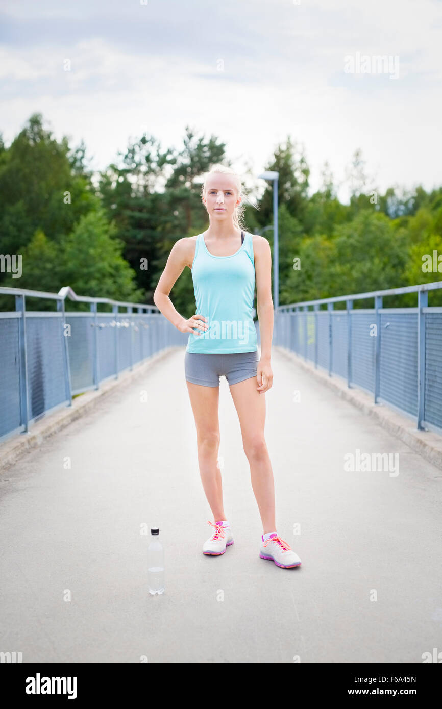 Confident female runner having her break after running Stock Photo - Alamy