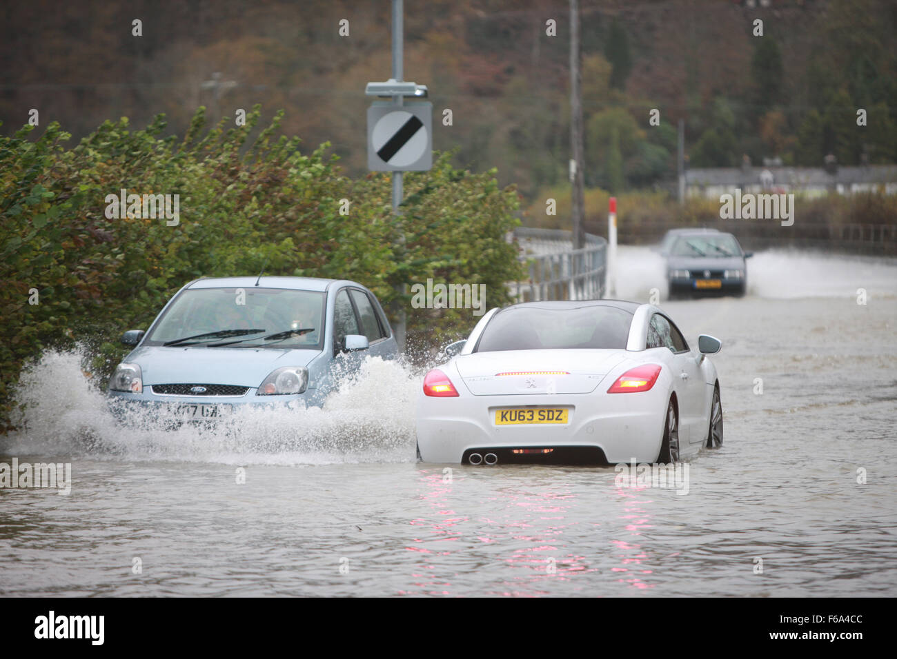 Cars driving through flooded road after torrential and prolonged ...