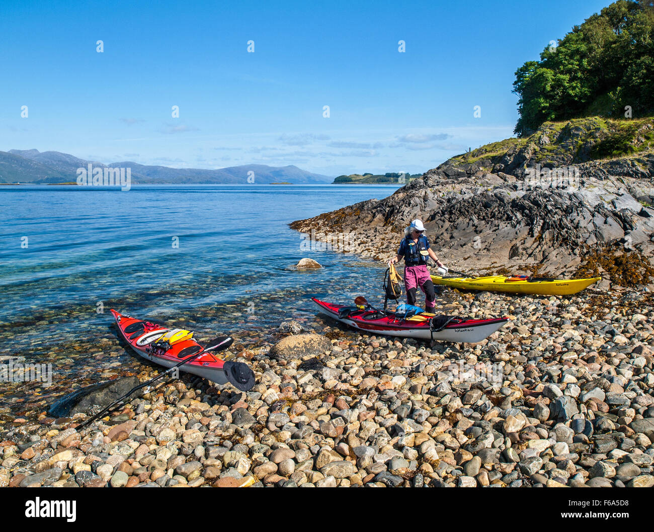 Group of retired people sea kayaking around Shuna Island on Loch Linnhe ...