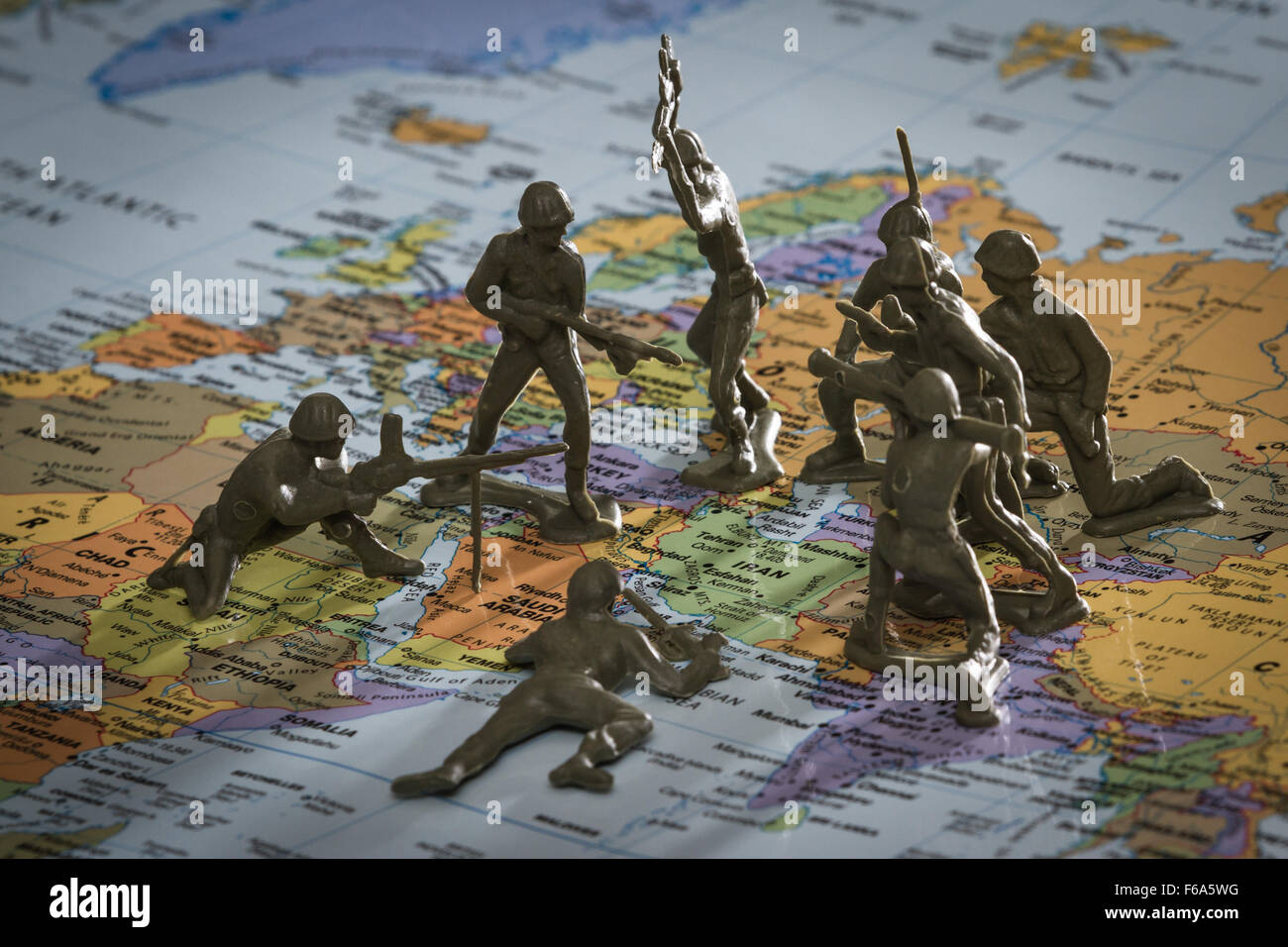 concept image using a wold map and toy soldiers to represent a war on ...