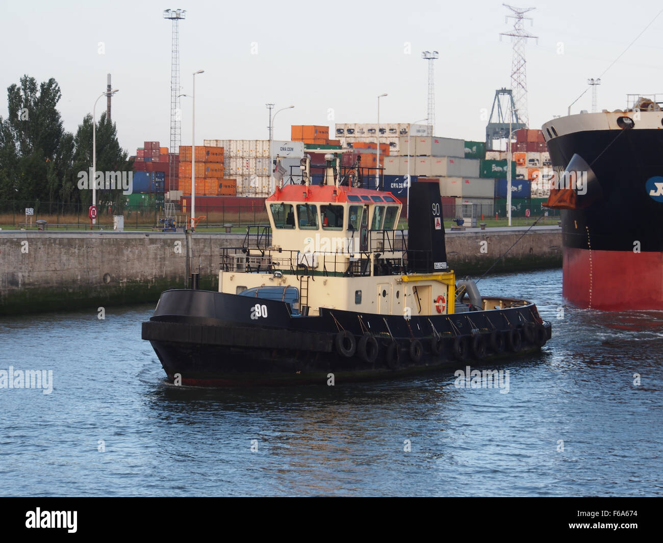 This photograph captures the Port of Antwerp with various ships ...