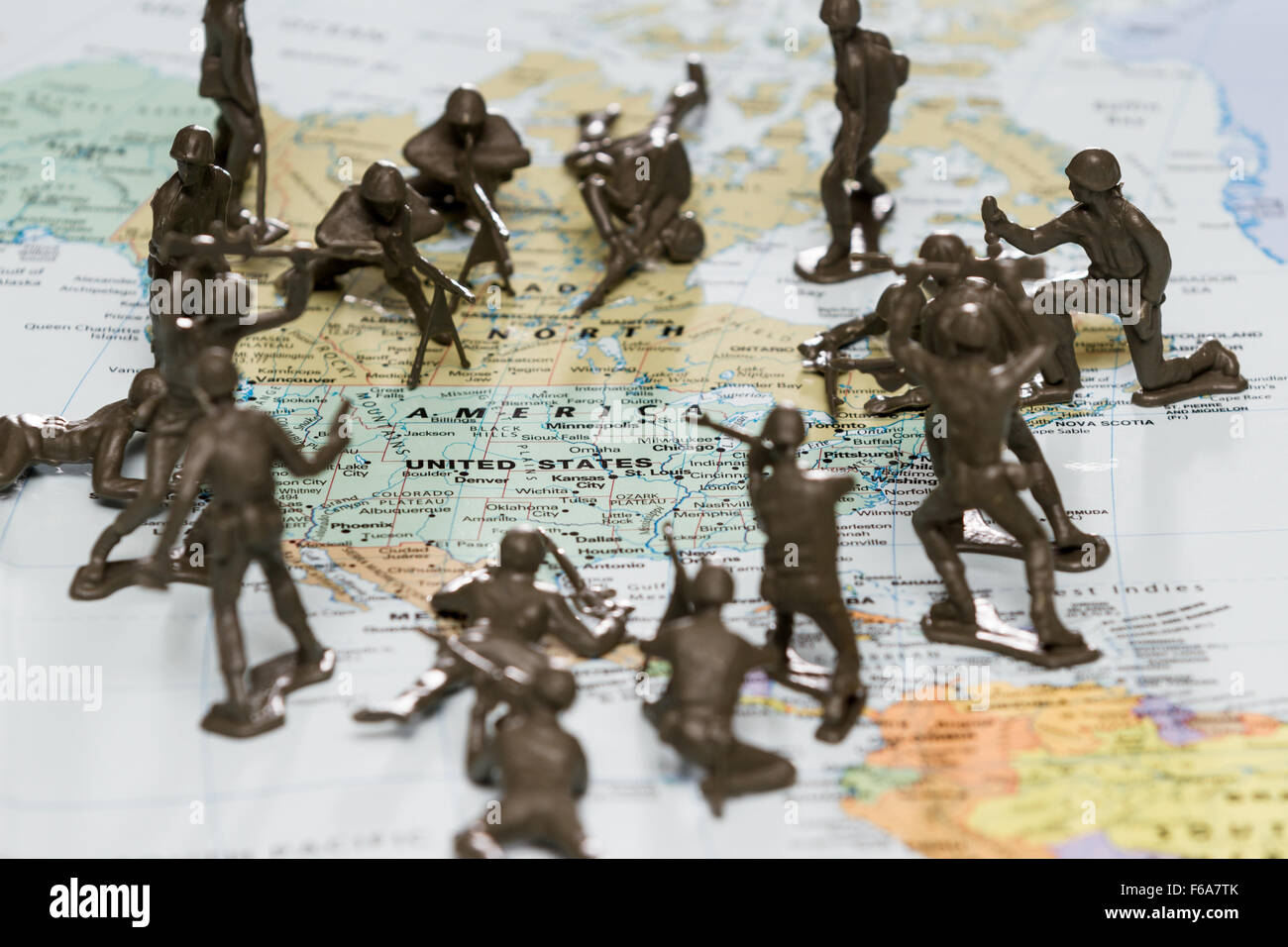 concept image using a wold map and toy soldiers to represent a war on ...