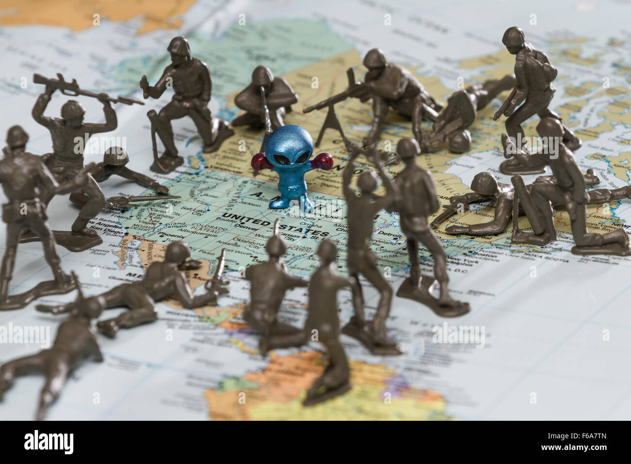 concept image using a wold map and toy soldiers to represent an alien ...