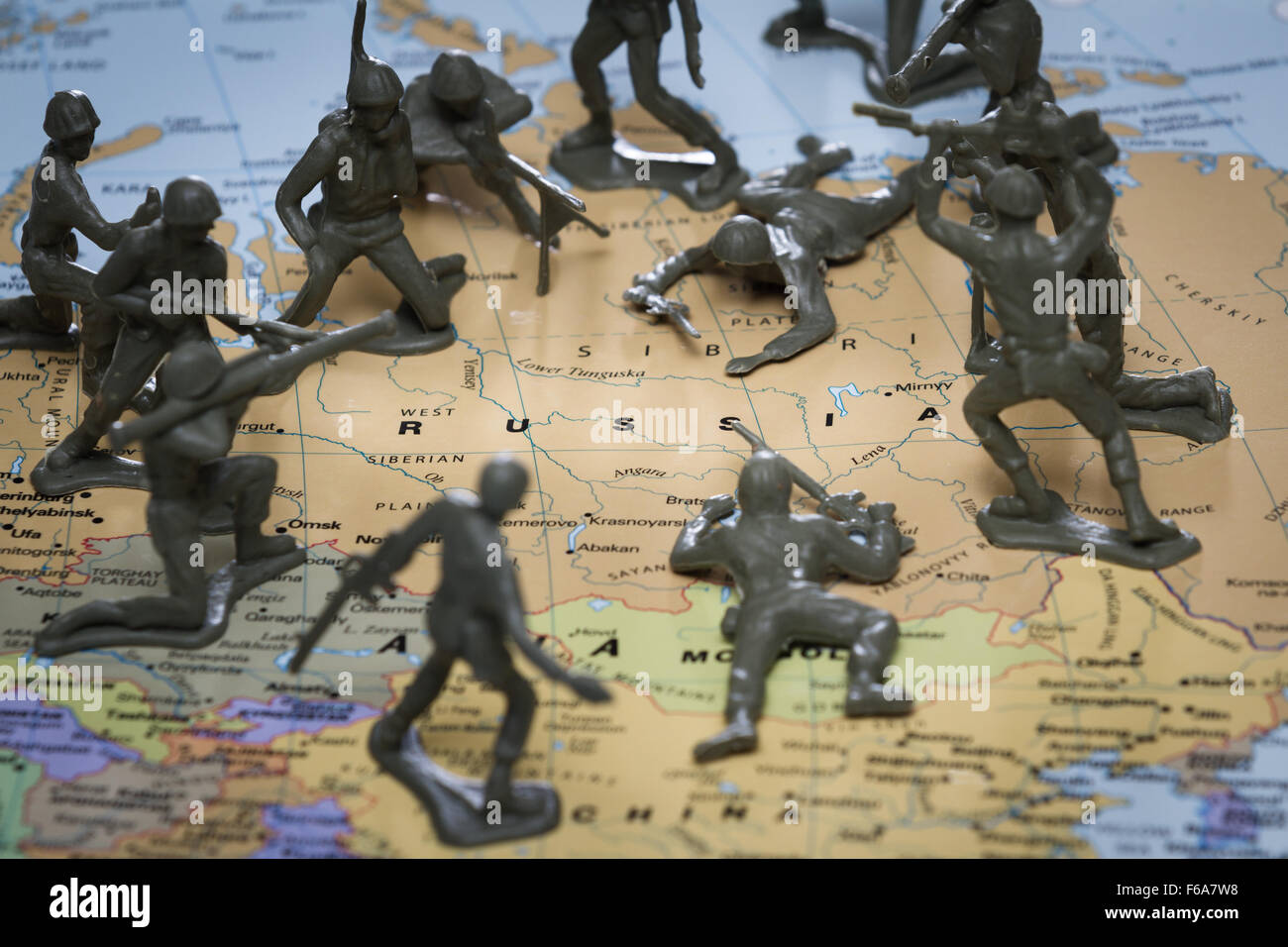 concept image using a wold map and toy soldiers to represent a war on ...