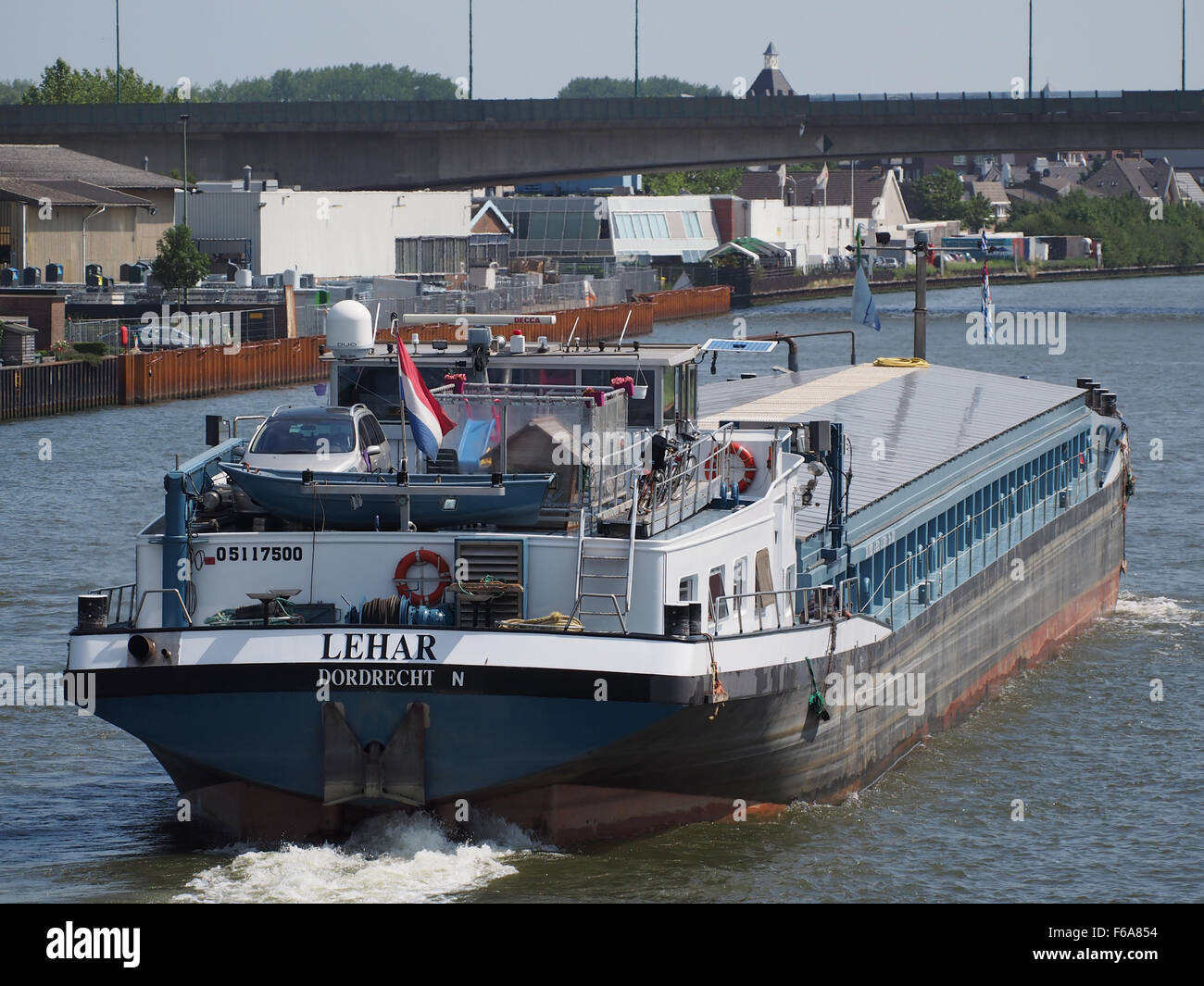 This image shows a container ship docked at the Amsterdam-Rijn Canal ...