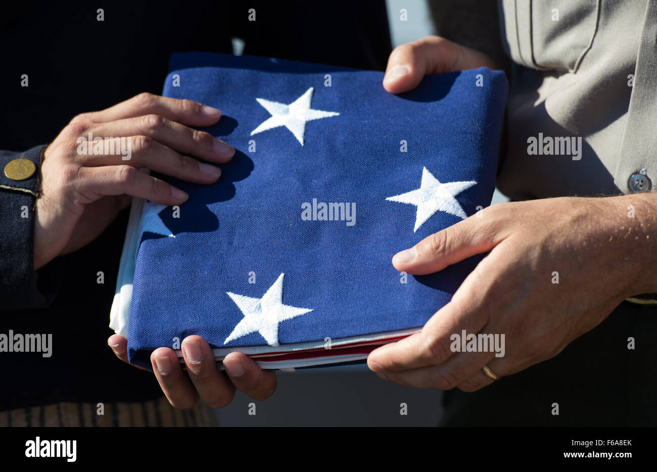 Tyler Mink and Vince Vaise hold a replica of the Star Spangled Banner ...