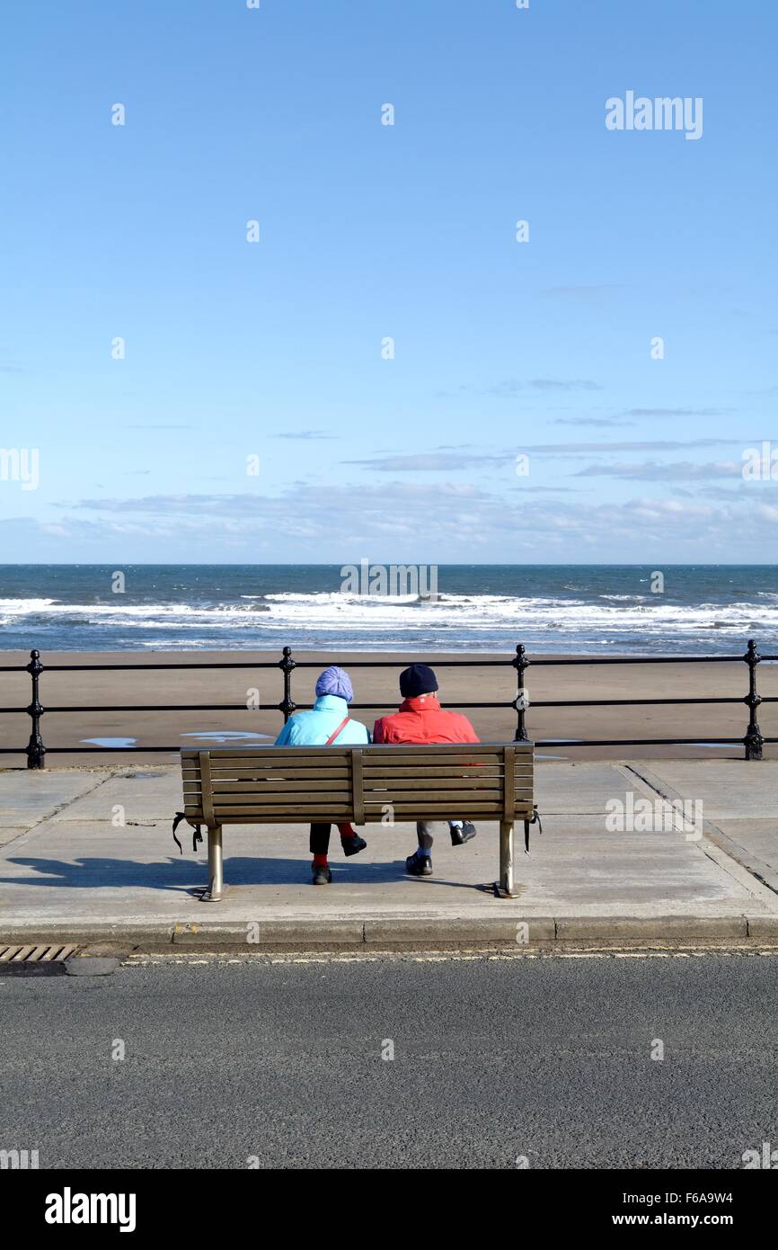 Elderly couple sitting on seafront bench in Scarborough Yorkshire Stock ...