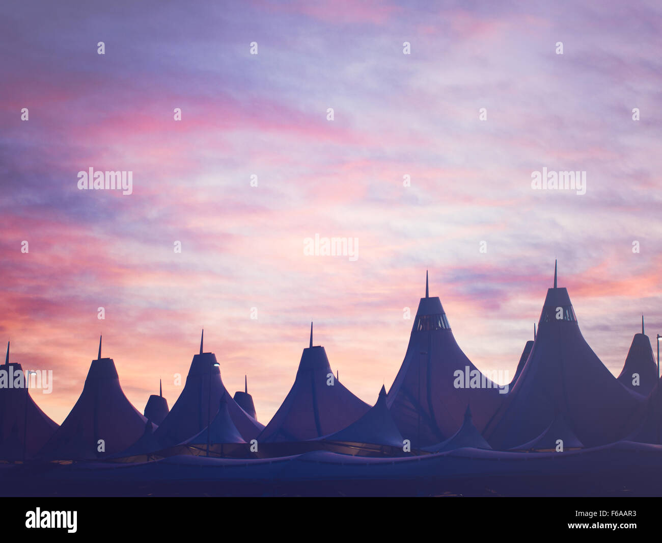 Glowing tents of DIA at sunrise. Denver International Airport well ...