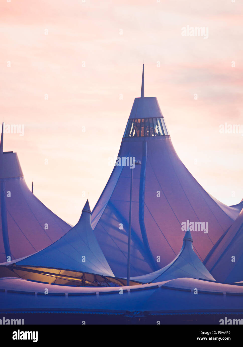 Glowing tents of DIA at sunrise. Denver International Airport well ...