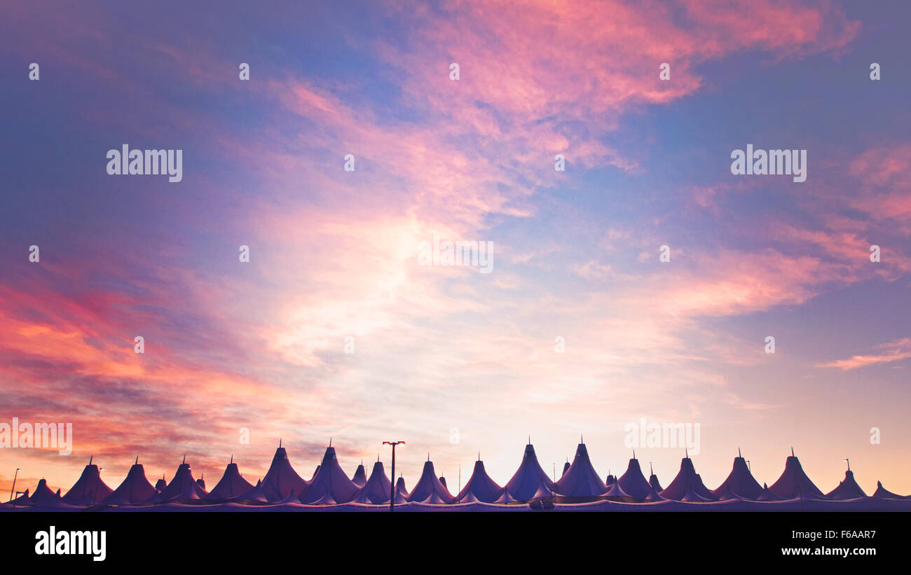 Glowing tents of DIA at sunrise. Denver International Airport well ...