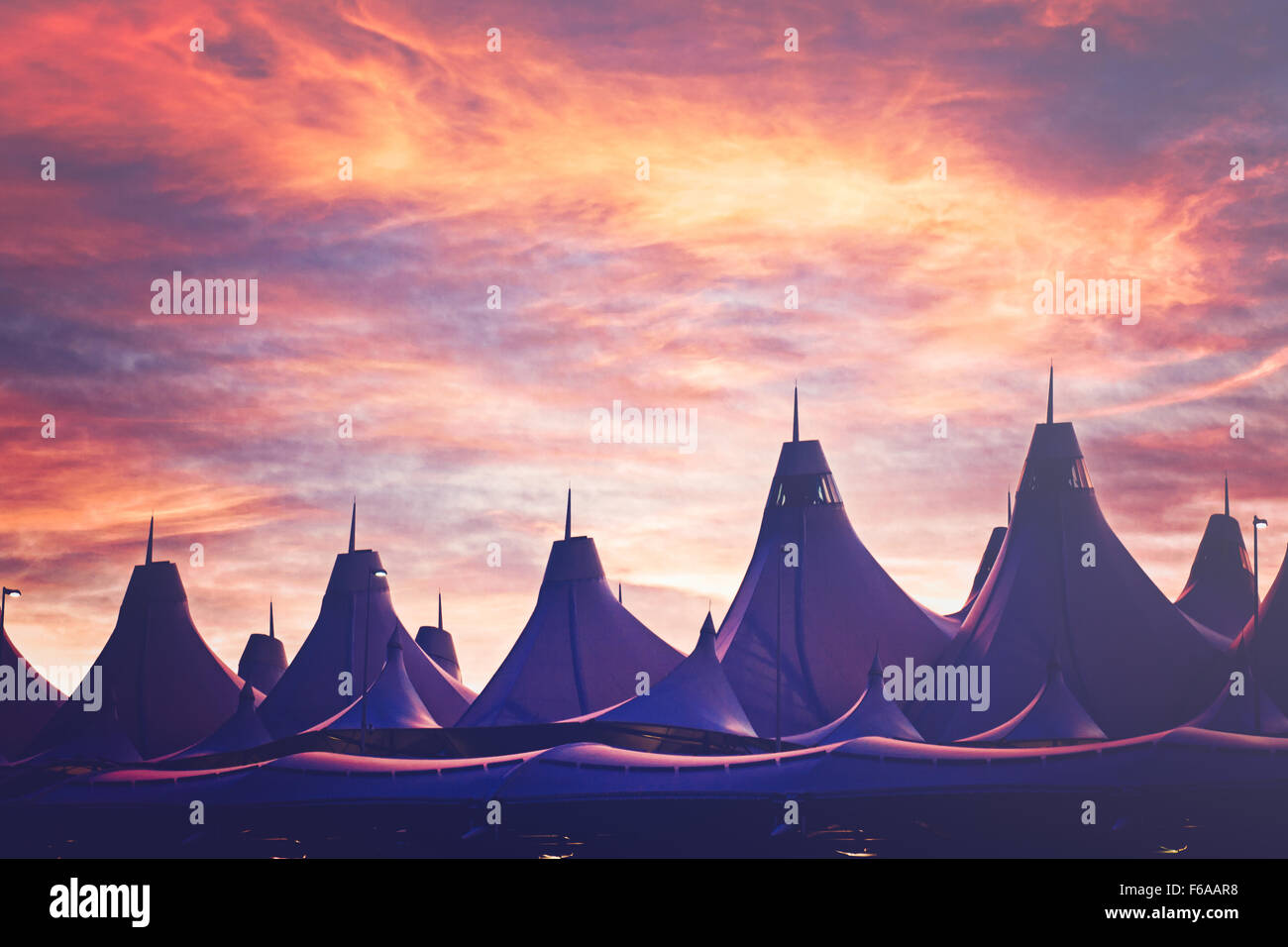 Glowing tents of DIA at sunrise. Denver International Airport well ...