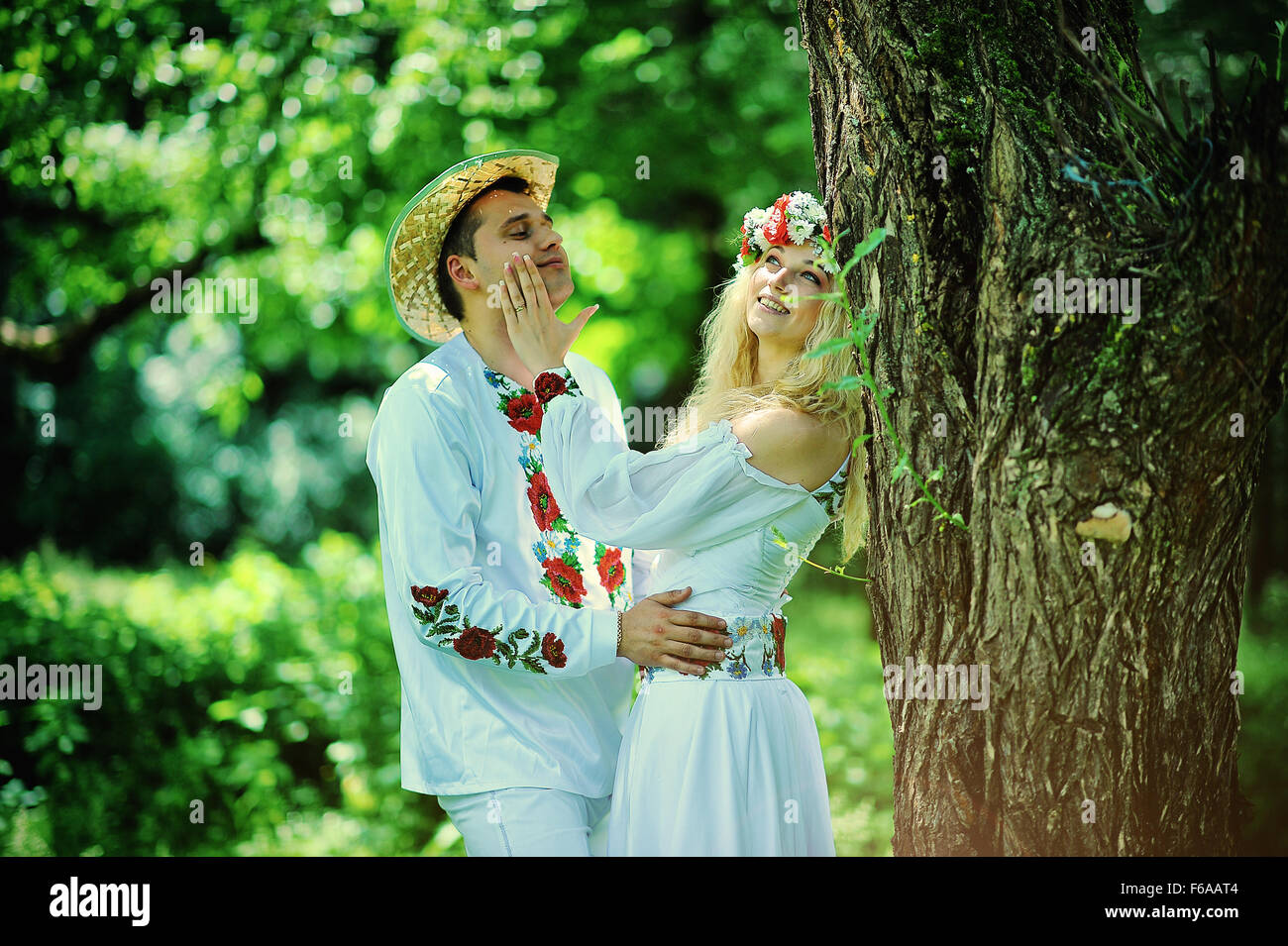 Young beautiful couple in traditional dress flirt Stock Photo - Alamy
