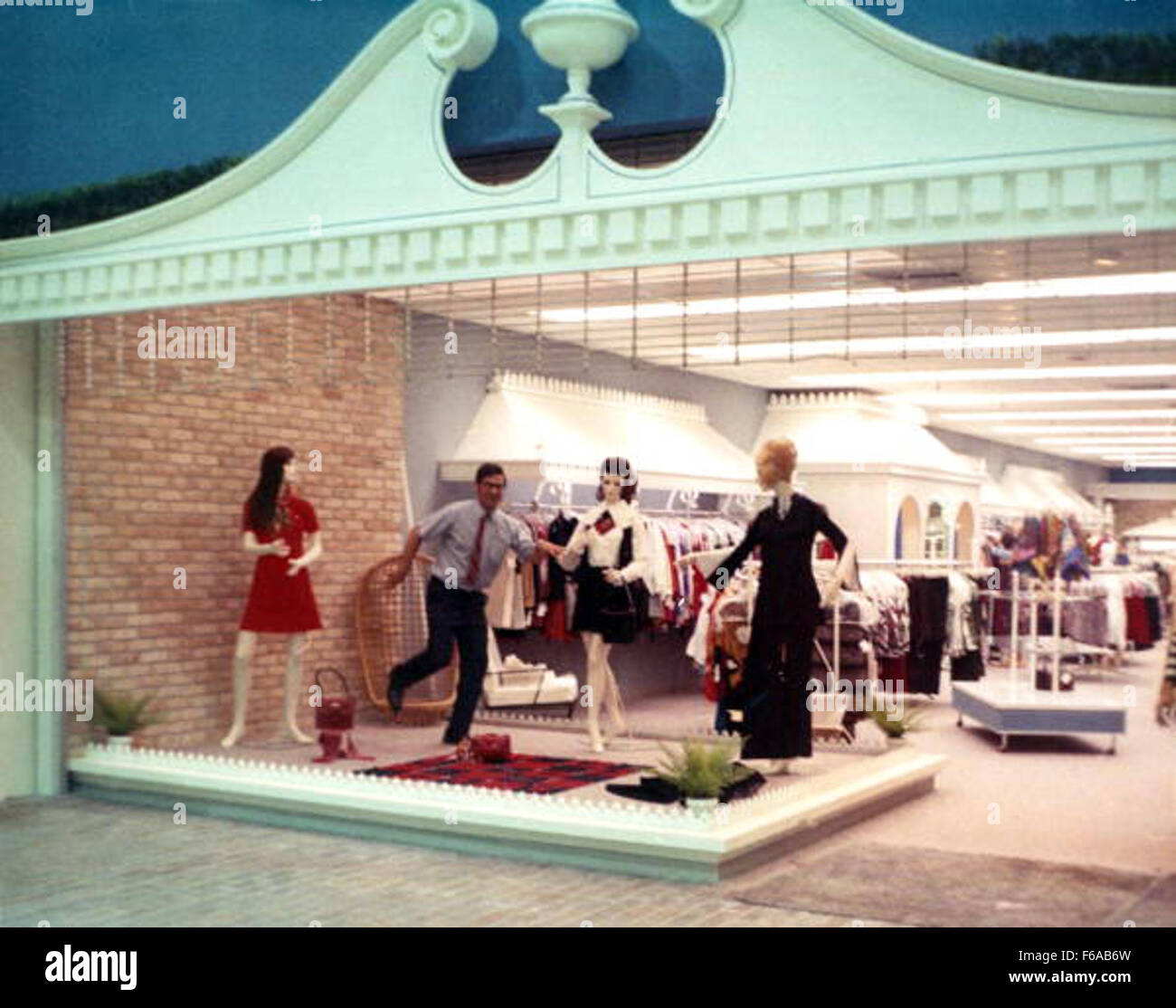 A historical image showing a man posing with mannequins at the Colony ...